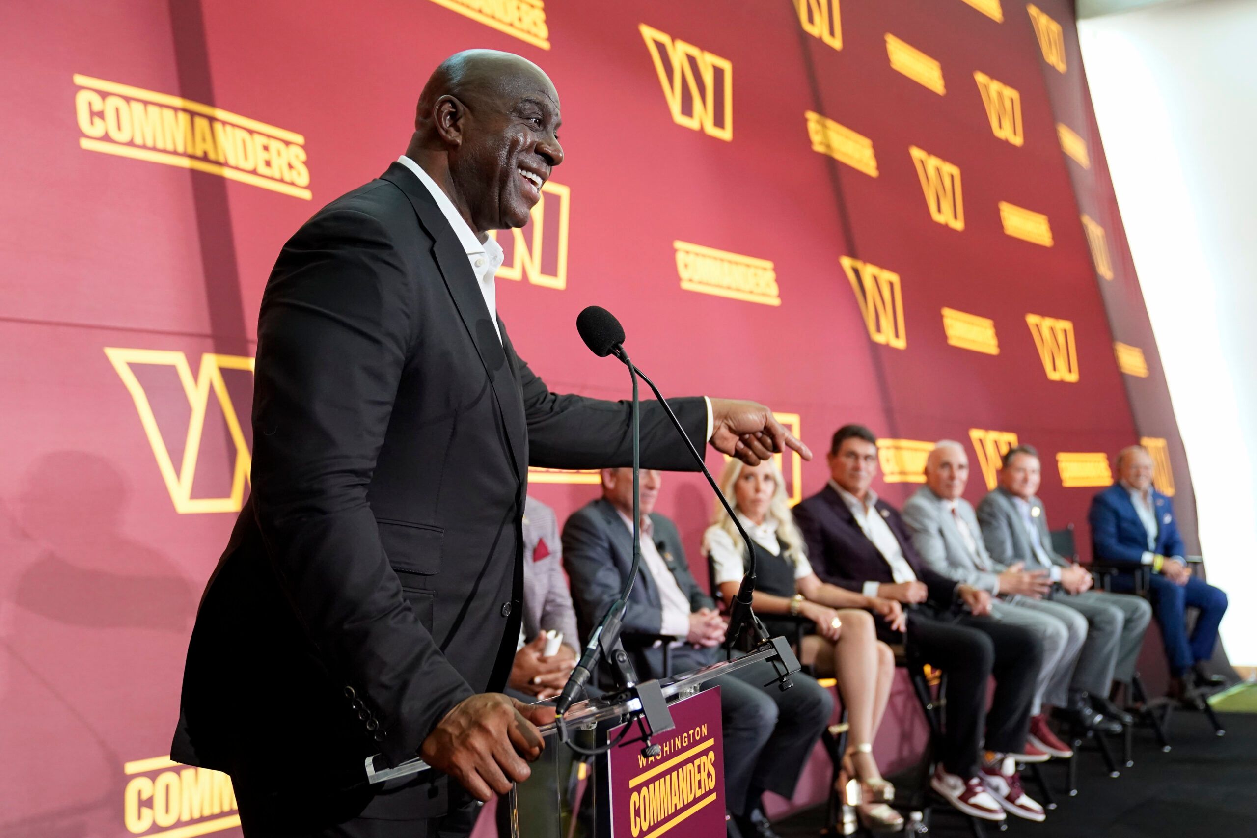 Magic Johnson, part owner of the Washington Commanders, meets with ...