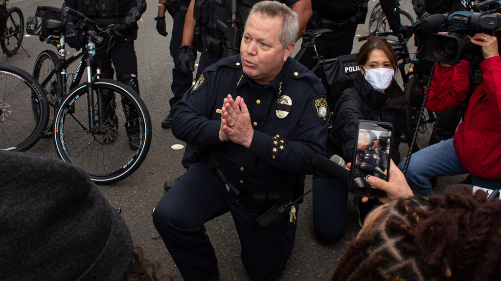 Don't be fooled by seemingly good cops kneeling at protests -- it's a stunt